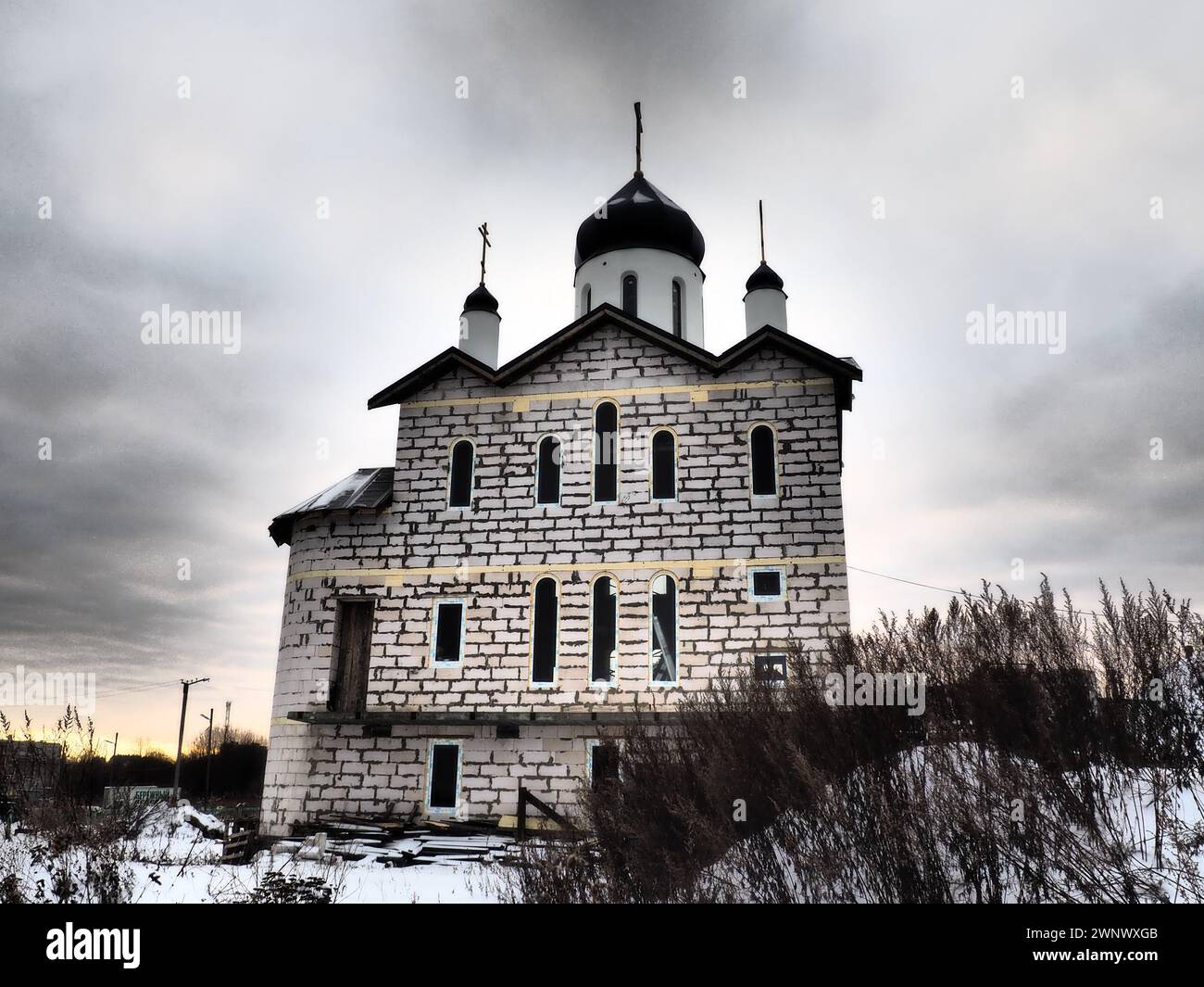 A church with domes under a dramatic sky. Stylized photo under black ...