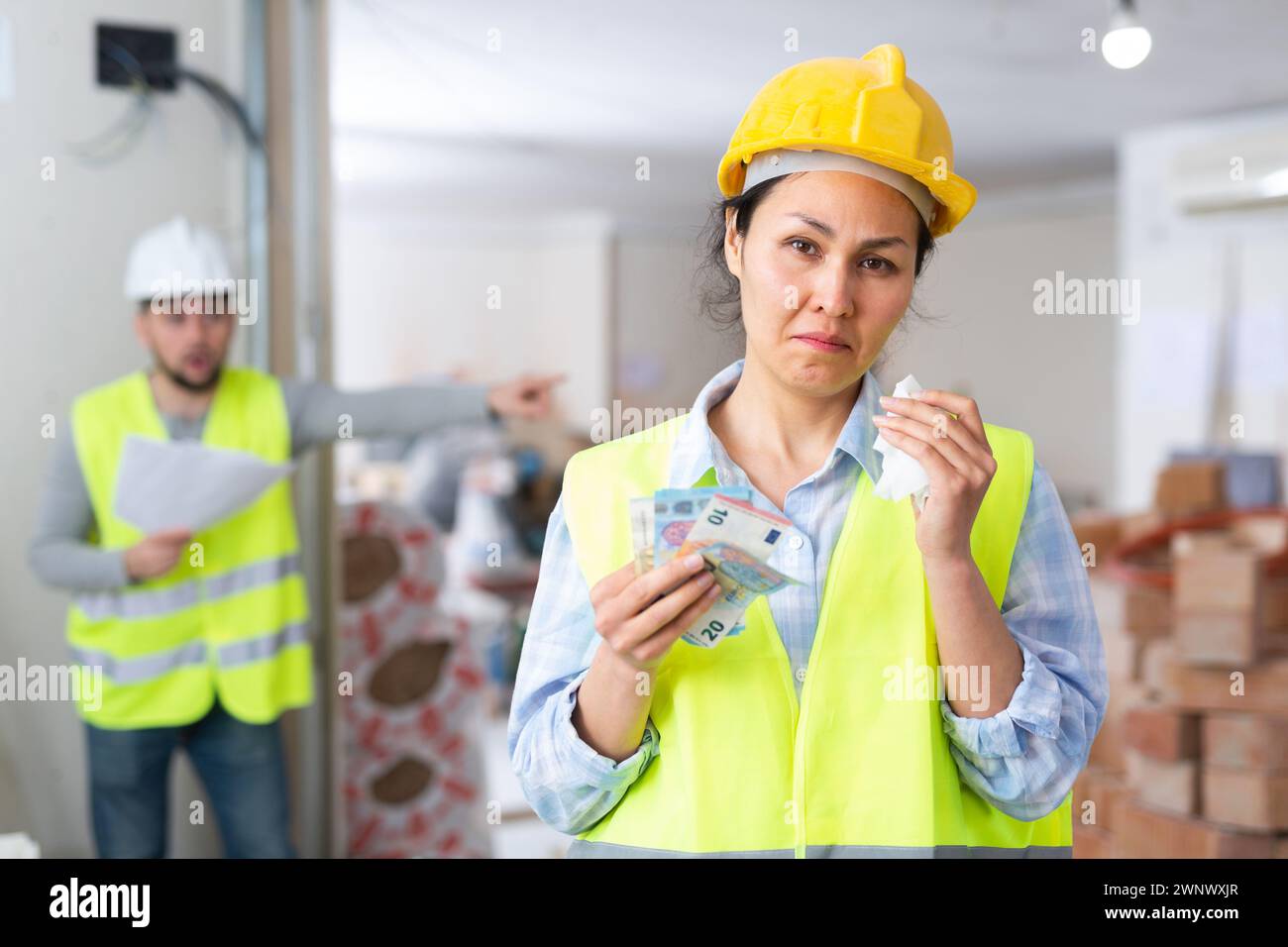 Woman builder crying because of low wages Stock Photo - Alamy