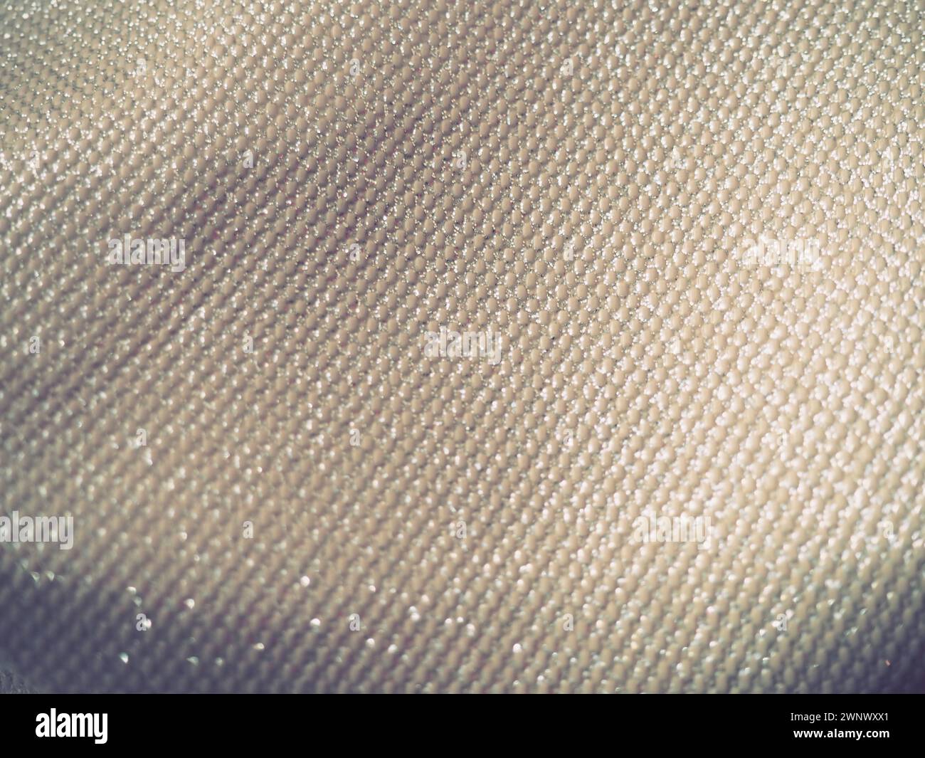 A close-up fabric with lurex. The texture of the fabric with grooves and lines. It's a uneven ...