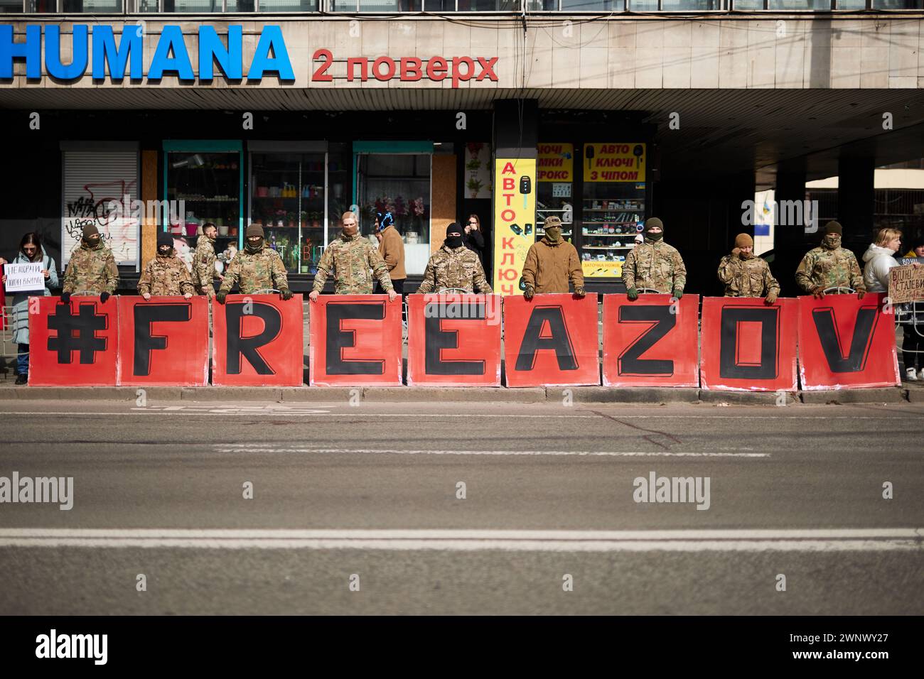 Ukrainian soldiers hold a banner "Free Azov" on a rally demanding for ...