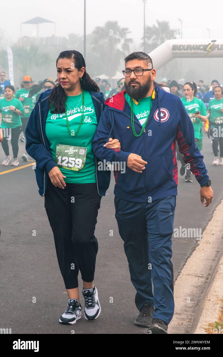 Man and woman, arms hooked together, walk on a foggy day in the 18th ...