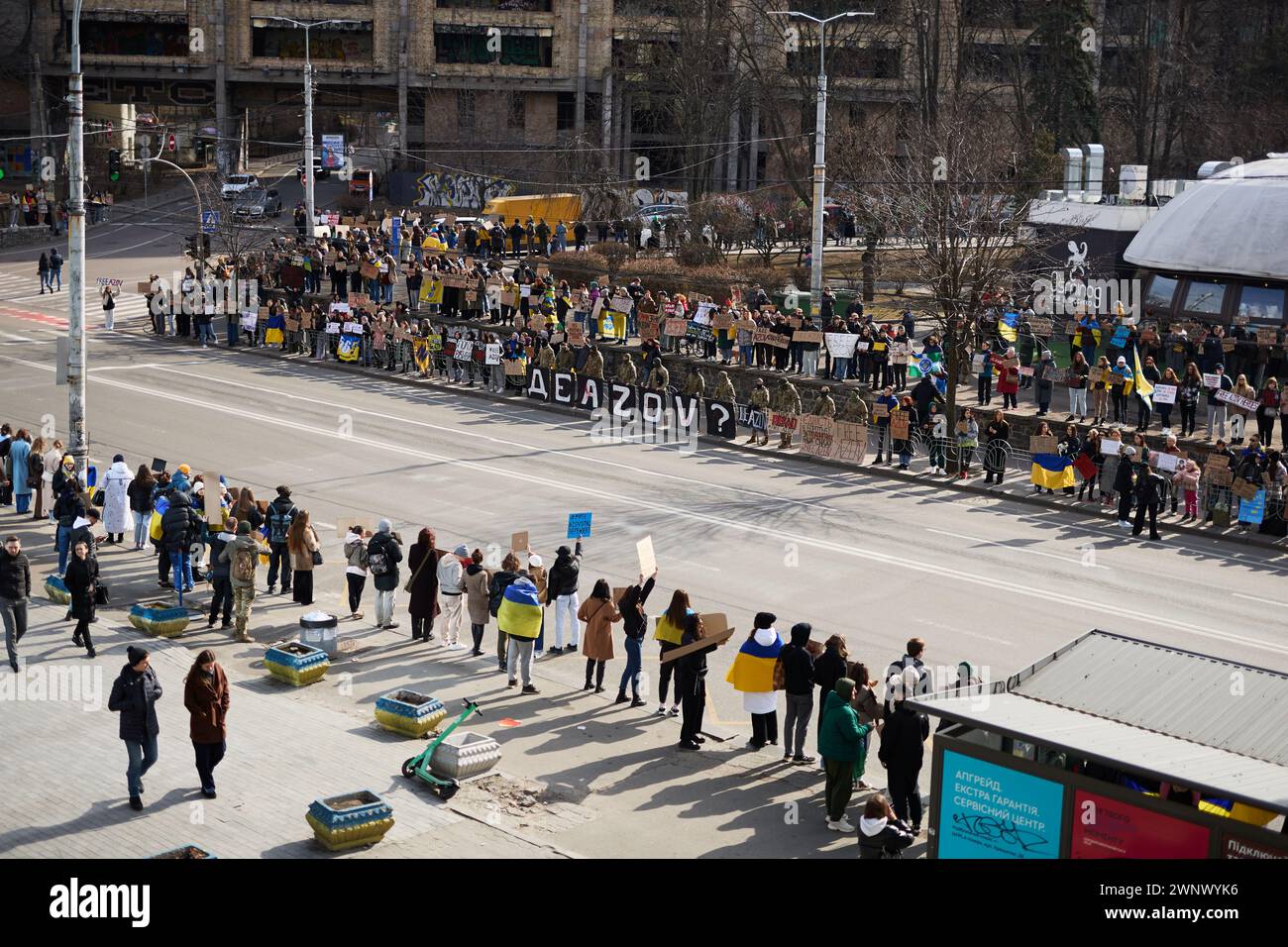 Large group of Ukrainian activists stand by the road with banners "Free ...