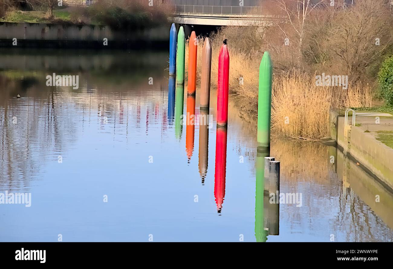 Coloured mooring posts along the Waterwork River, Stratford Stock Photo ...