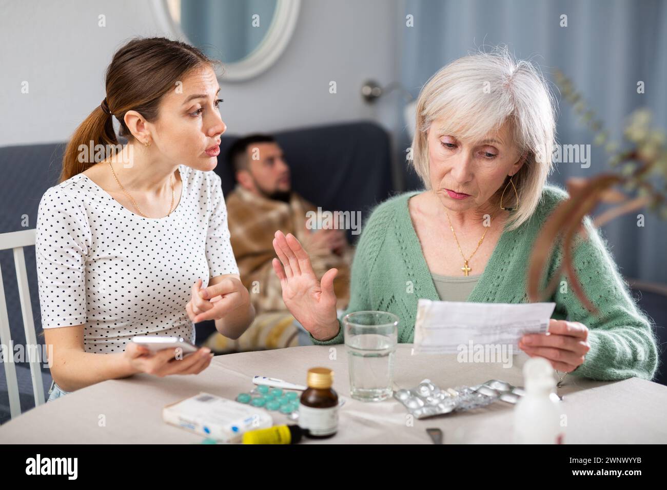 Women choosing medicines for sick adult man Stock Photo - Alamy
