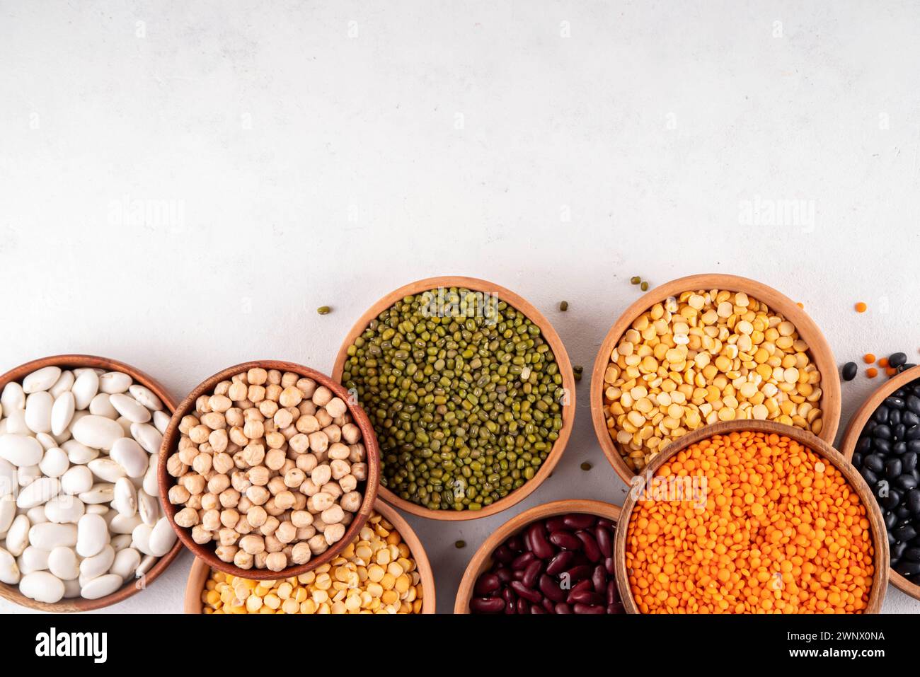 Various dried beans, lentils, mung, chickpea, pea assortment in wooden ...