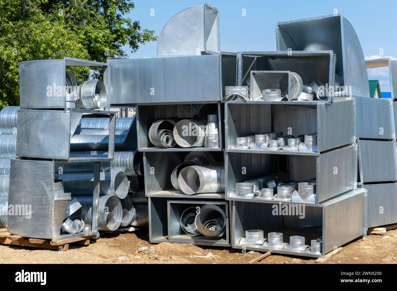 Various sheet metal air ducts in stock for installation in a building ...