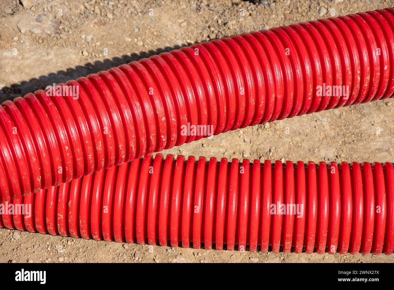 Red plumbing pipe close-up. Drainage, tubing, pipes. Red pipes of the water supply and heating ...