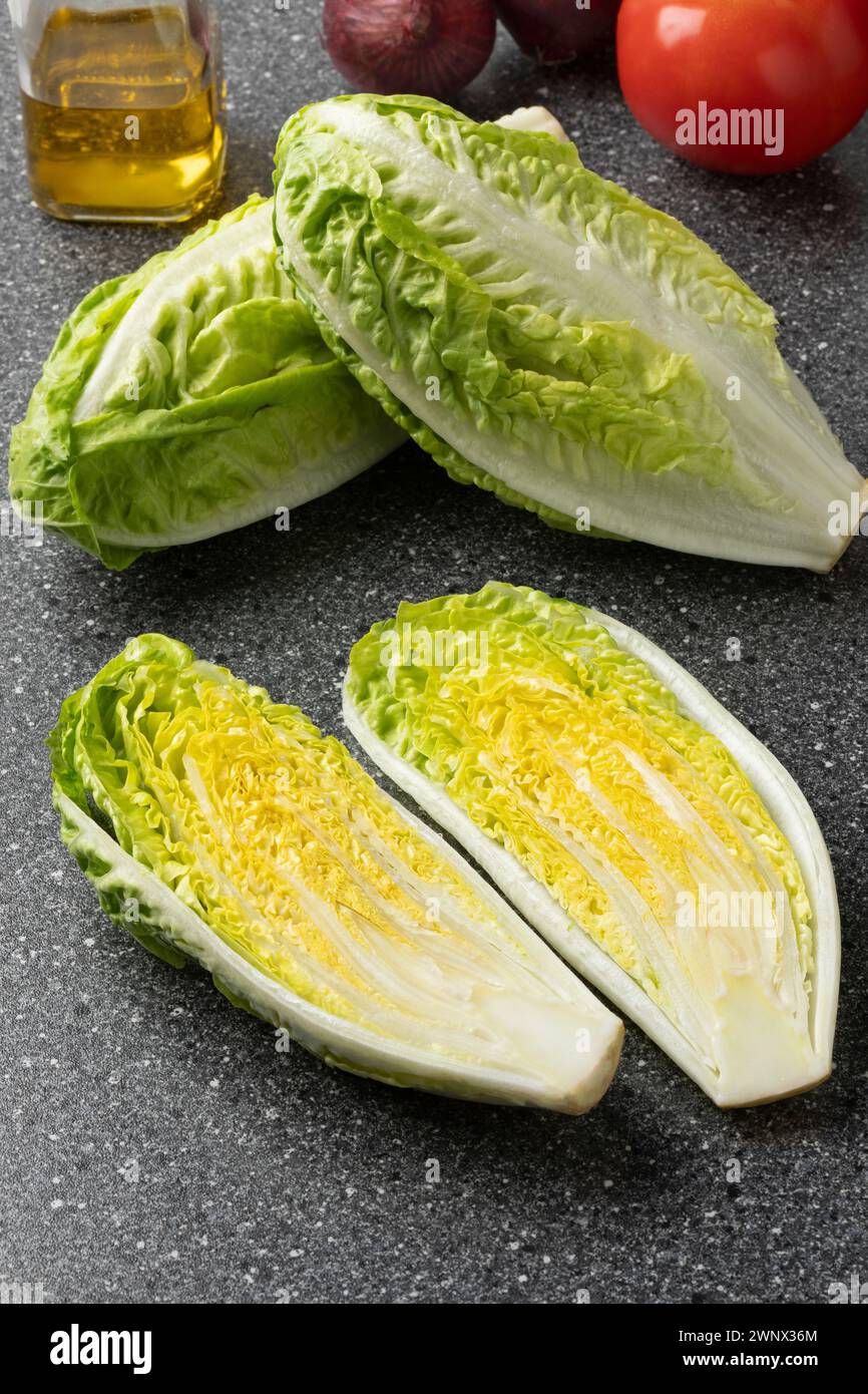 Little whole and halved fresh raw Romaine lettuce in the kitchen Stock ...