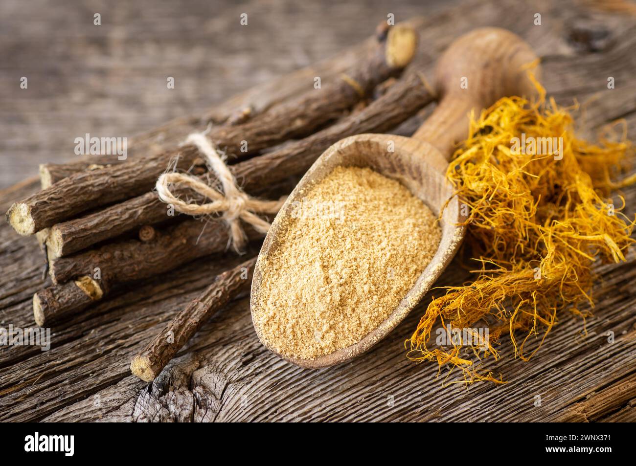 Licorice root, licorice fiber and powder or bowl in spoon on rustic ...