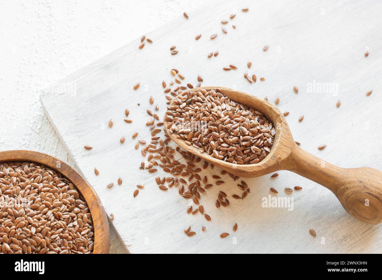 Heap of Flax seeds or linseeds in spoon on rustic background. Flaxseed concept, dietary fiber ...