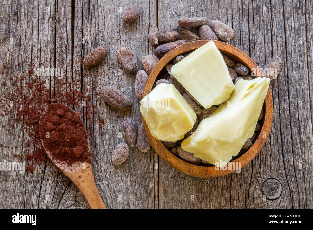 Cocoa butter or Cocoa bean solid oil and raw cocoa beans on rustic ...
