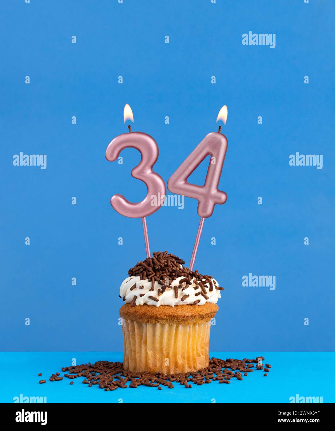 Candle number 34 - Birthday card with cupcake on blue background Stock ...