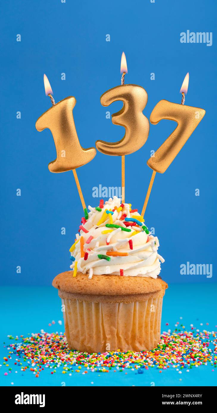 Candle number 137 - Cupcake birthday in blue background Stock Photo - Alamy