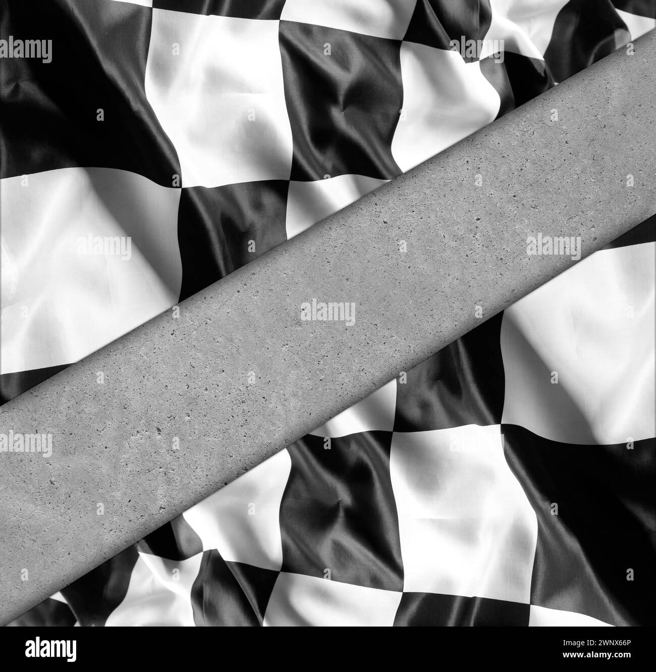 Checkered black and white flag on grey background Stock Photo - Alamy