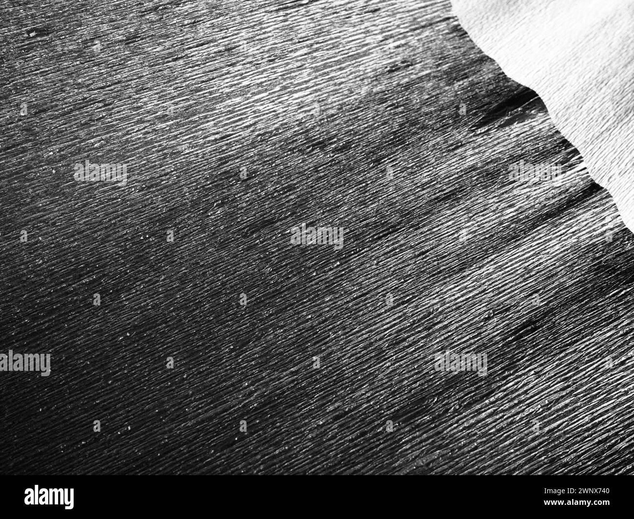 Black or gray corrugated paper. Uneven surface. Abstract monochrome ...