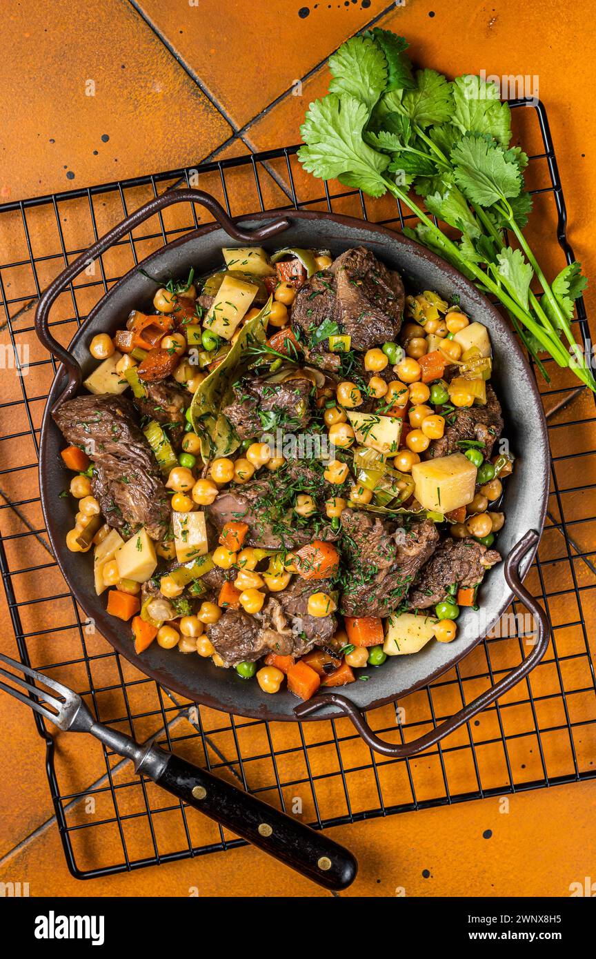 Spanish cocido Madrid stew with chickpeas, meat, carrots and potatoes ...
