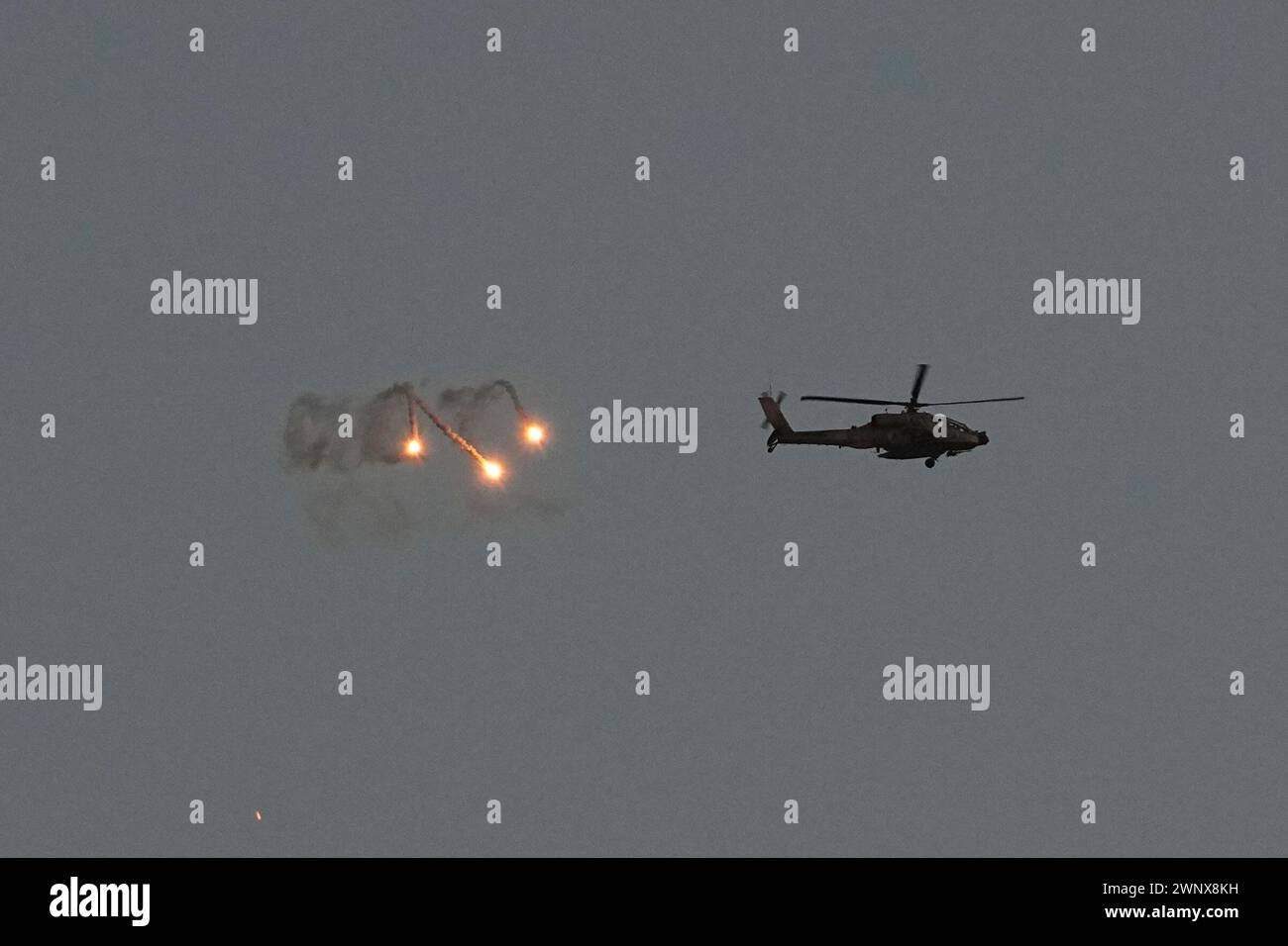 An Israeli Apache helicopter fires flares over the Gaza Strip as seen ...