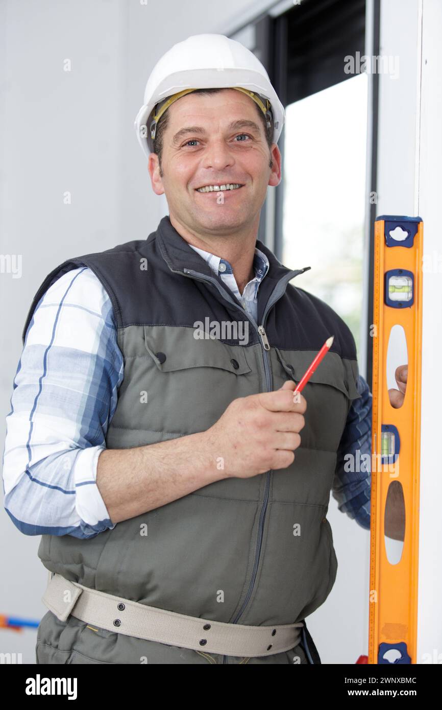 Construction worker using spirit level hi-res stock photography and ...