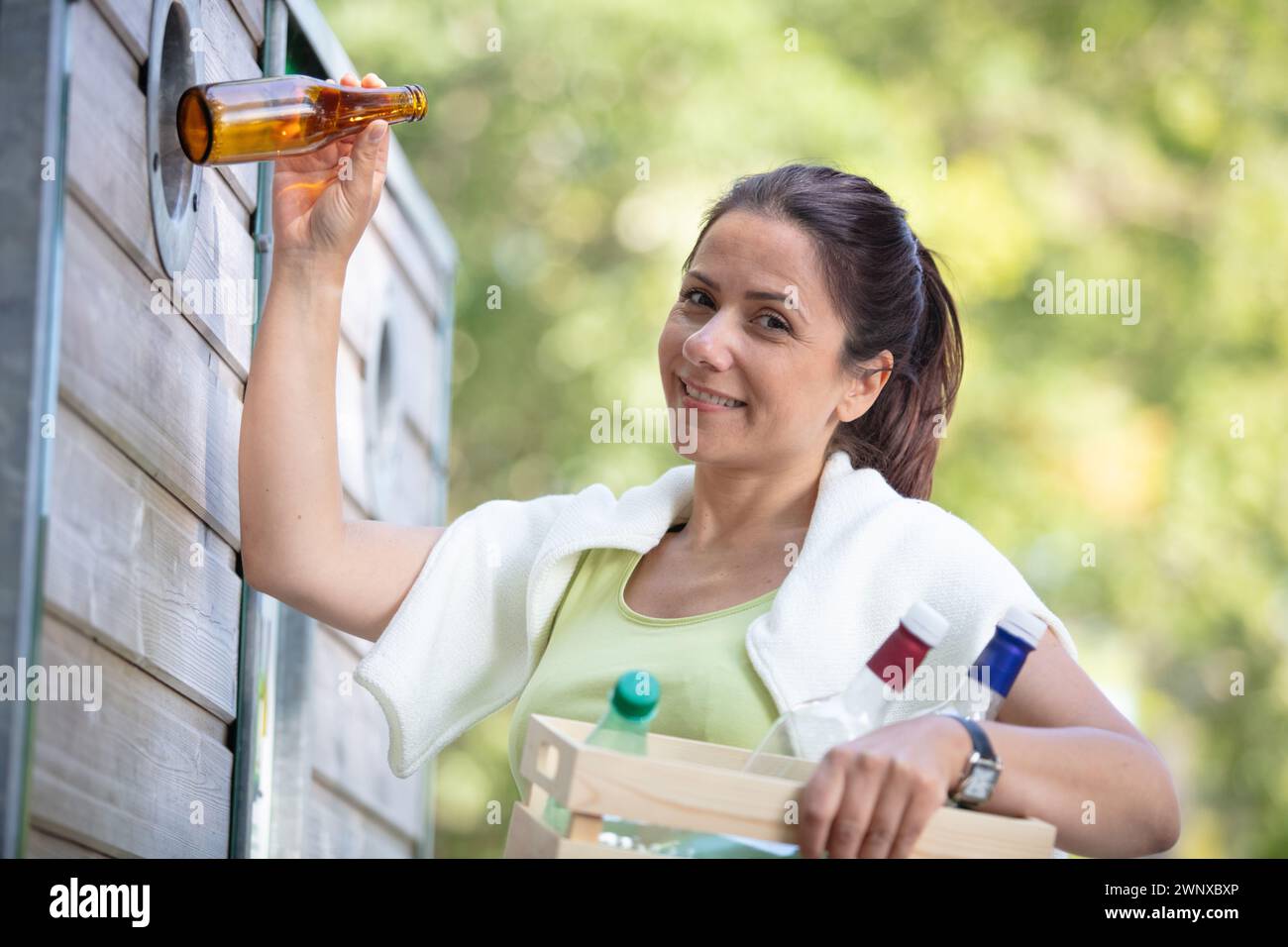 recycle recycling woman bin with glass bottles Stock Photo - Alamy