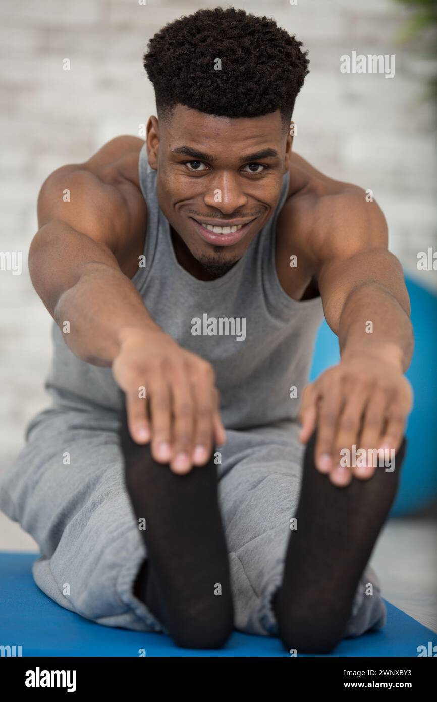 handsome young man doing hamstring stretch exercise Stock Photo - Alamy