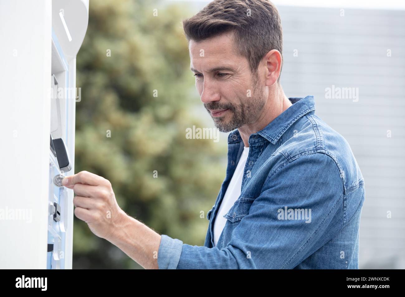 man using vending ticket machines to take the train Stock Photo - Alamy
