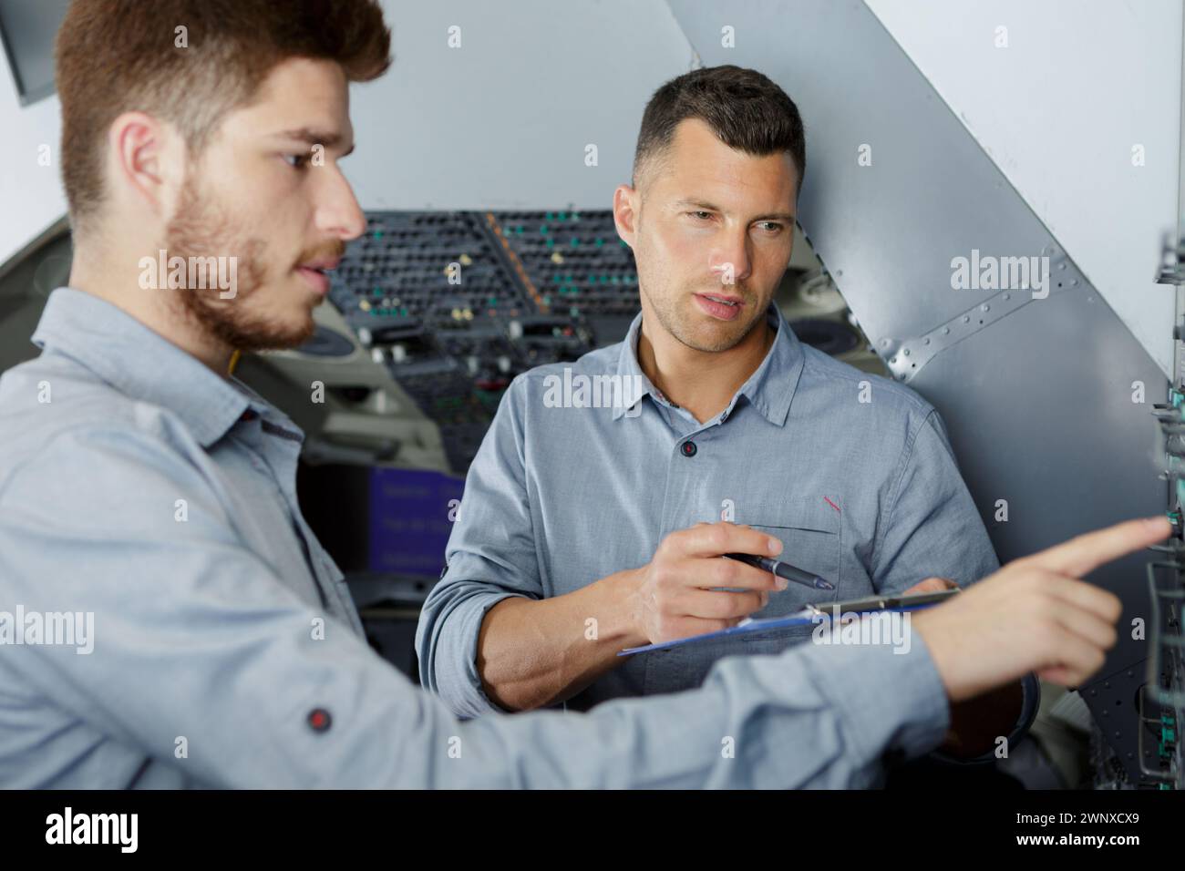 apprentice engineer working on control panel Stock Photo - Alamy