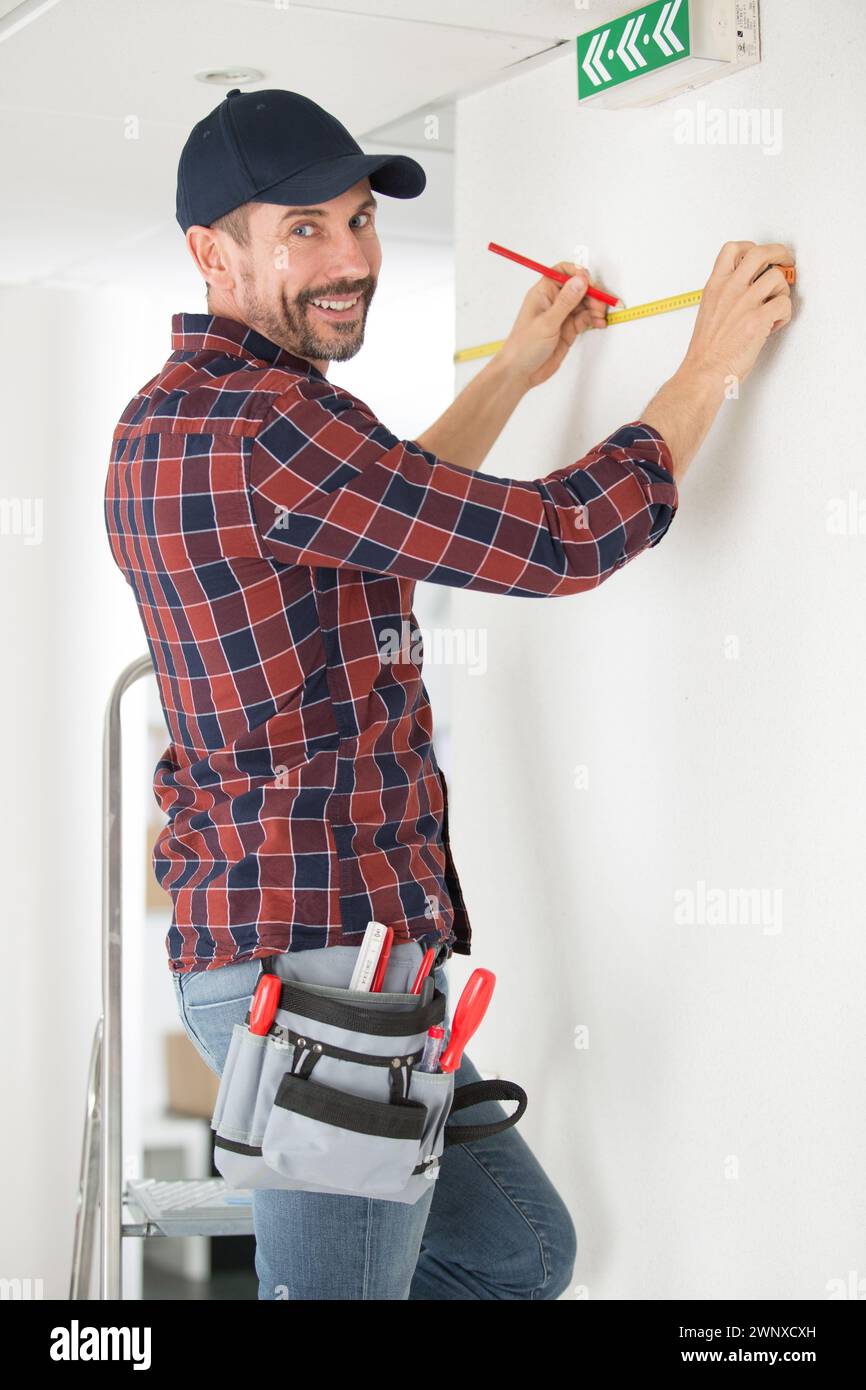 man using meter measuring the wall Stock Photo - Alamy