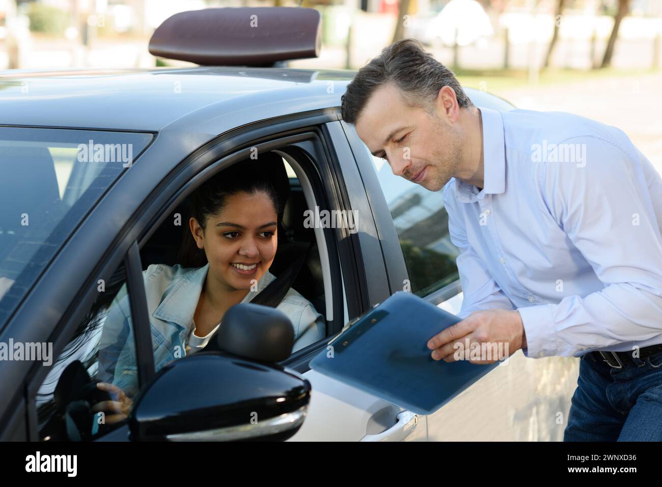 Woman showing license sitting hi-res stock photography and images - Alamy