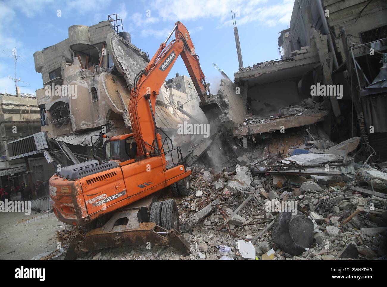 Gaza. 4th Mar, 2024. An excavator works on a destroyed building after ...