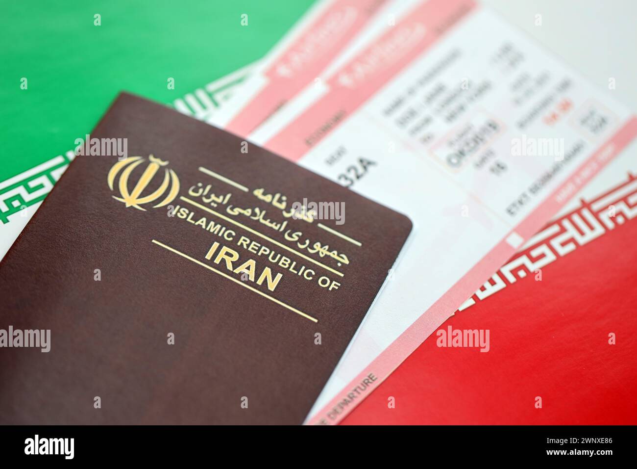 Red Islamic Republic of Iran passport with airline tickets on Iranian ...