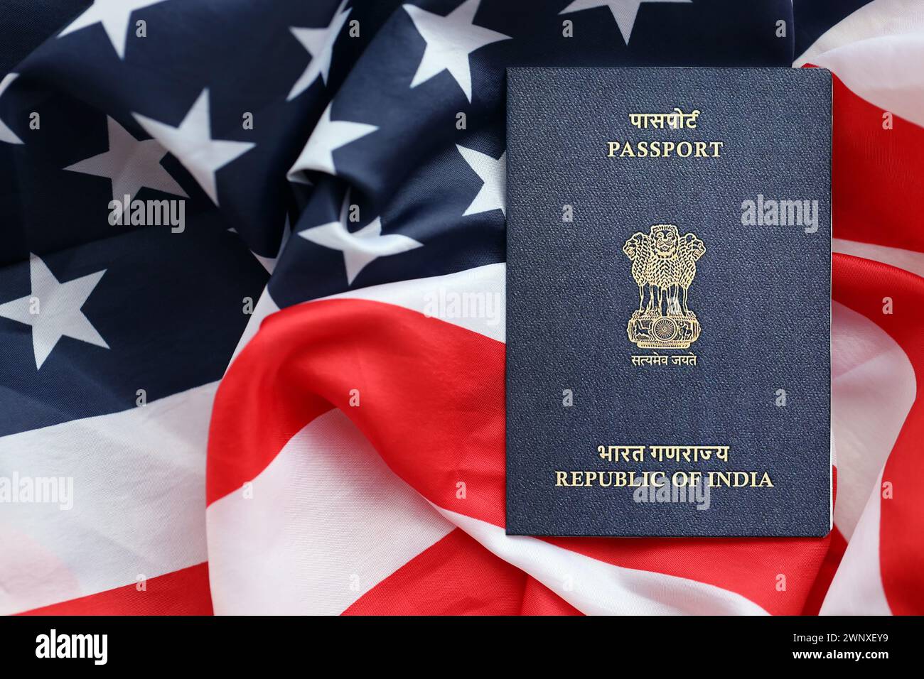 Blue Indian passport on United States national flag background close up ...