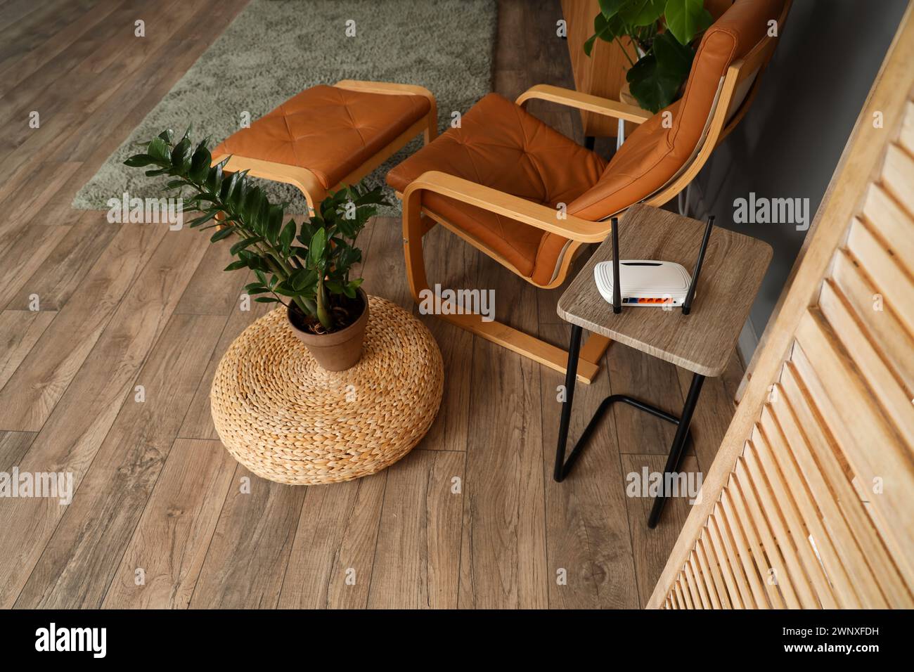 Interior of modern living room with armchair and wi-fi router on table ...