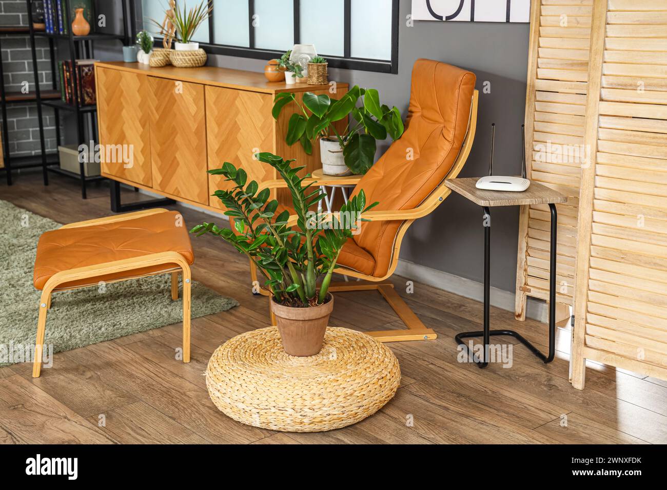 Interior of modern living room with armchair and wi-fi router on table ...