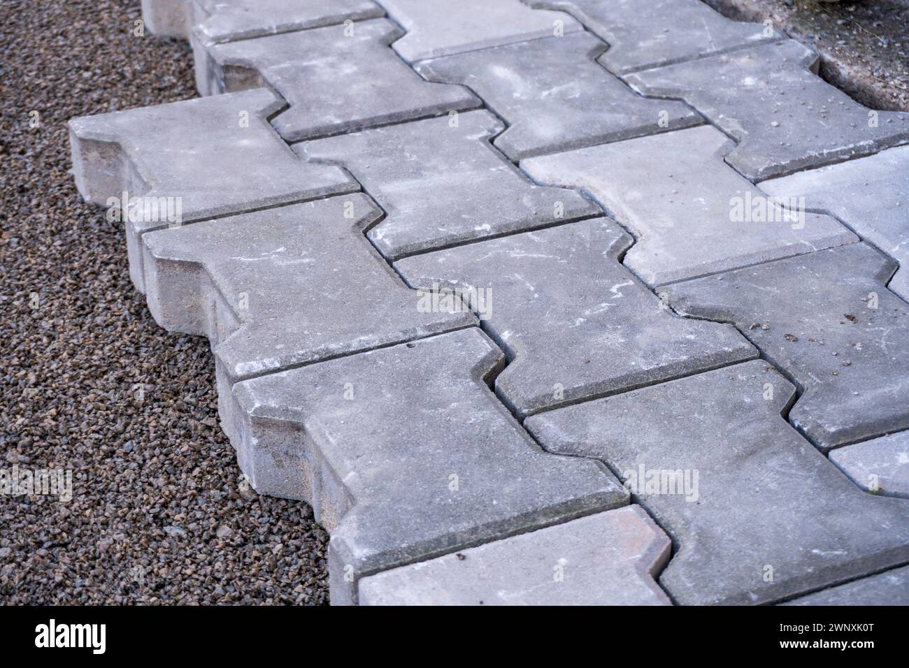 Laying gray concrete paving slabs in house courtyard driveway ...