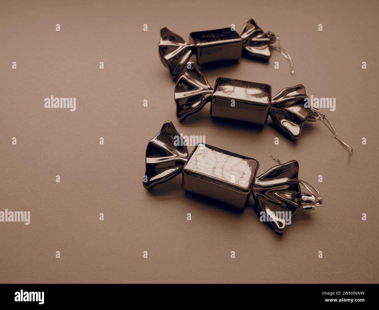 Christmas decorations in the form of sweets. Three candies in brilliant ...