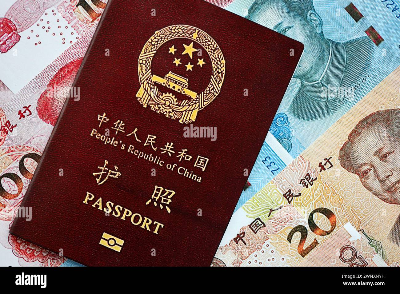 Red passport of People Republic of China and chinese yuan money bills ...