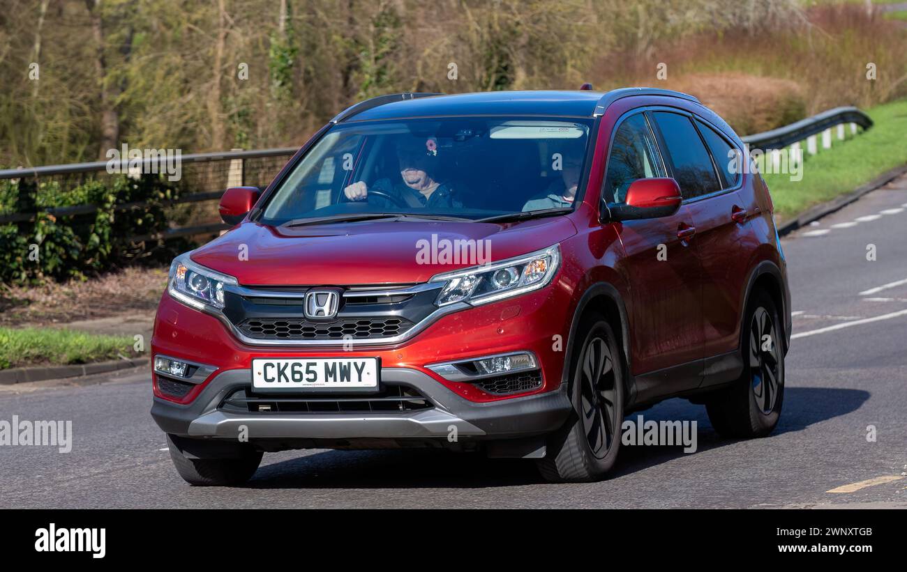 Milton Keynes,UK-Mar 4th 2024: 2016 red Honda CR-V diesel car driving on an English road Stock ...