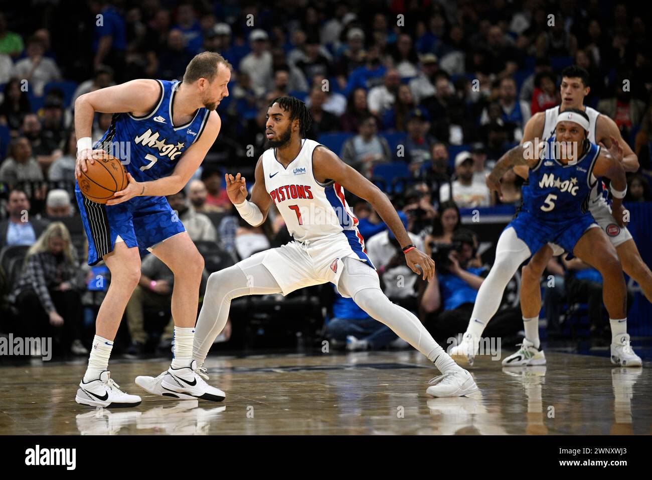 Orlando Magic guard Joe Ingles, left, is defended by Detroit Pistons ...