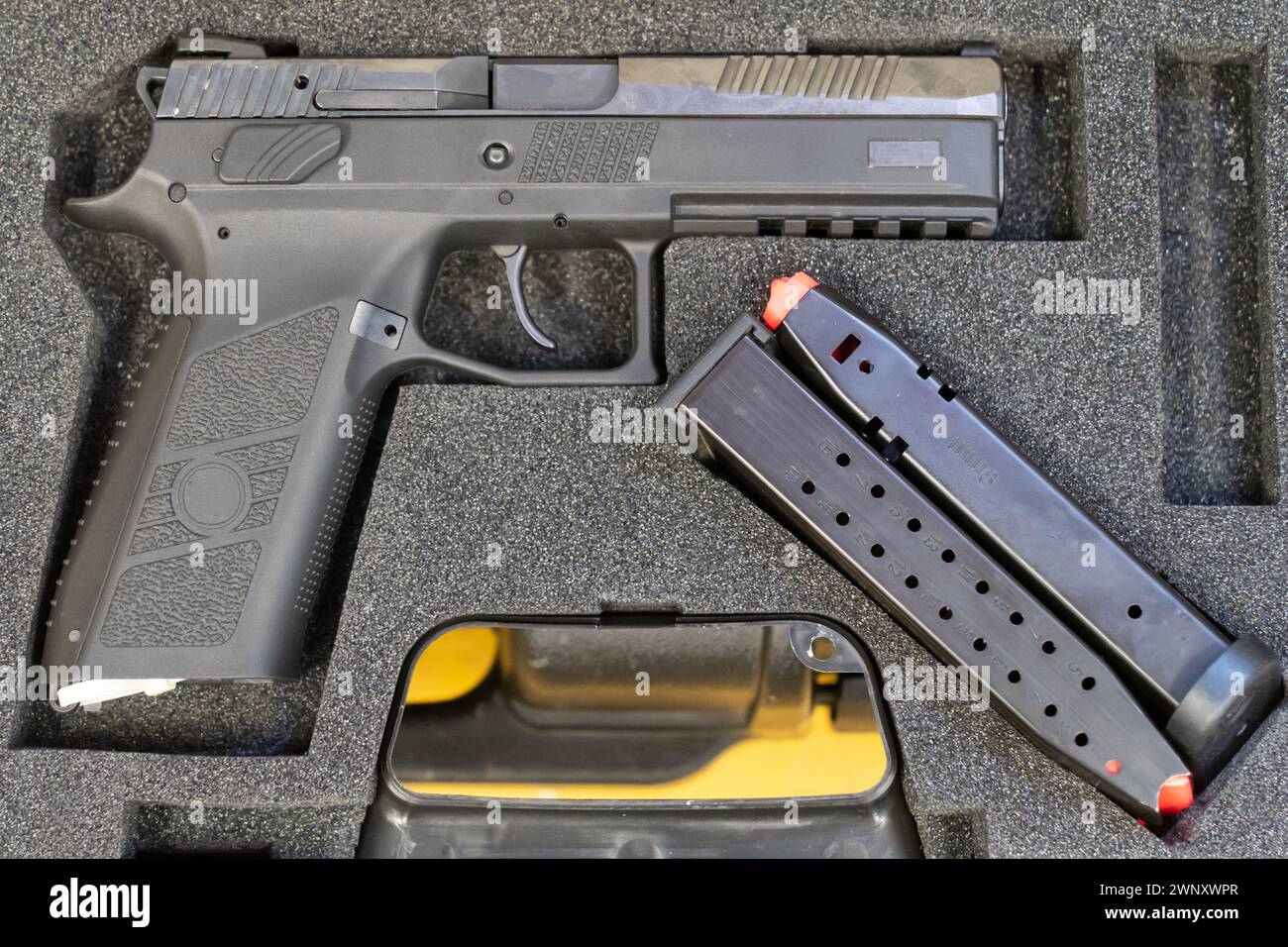 Modern semi-automatic pistol without magazine in a gun bag at an event ...