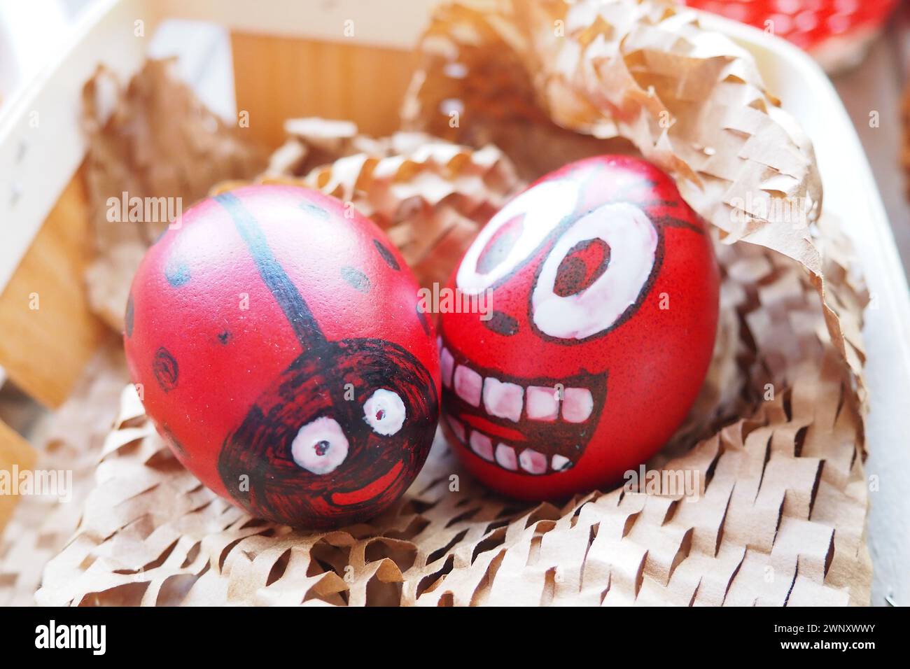 Easter eggs painted red, white and black with a cheerful faces. Boiled ...
