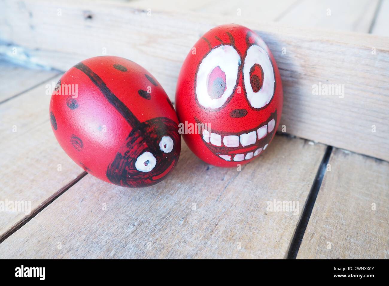 Easter eggs painted red, white and black with a cheerful fun faces ...