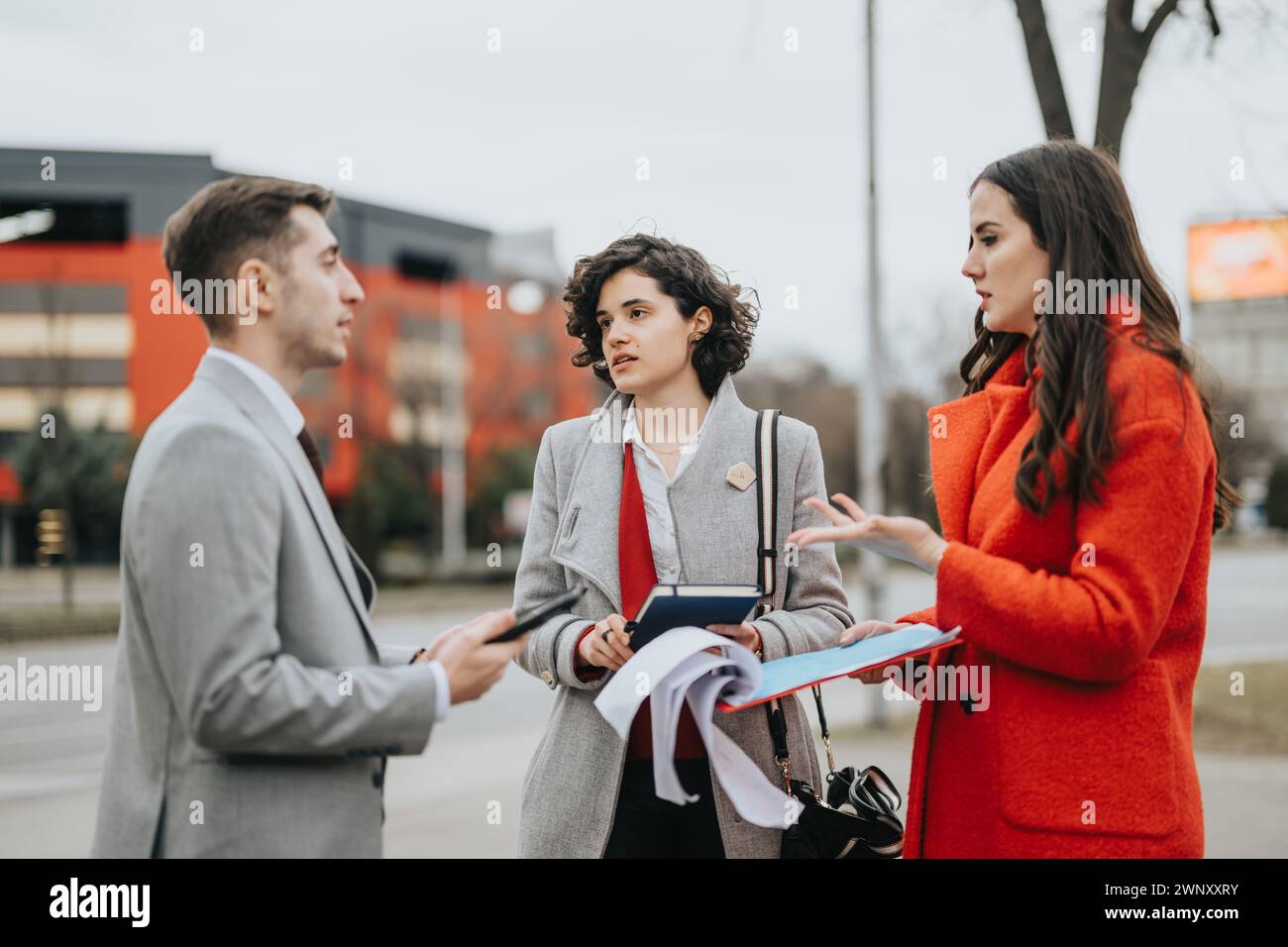 Business colleagues discussing project details outdoor Stock Photo - Alamy