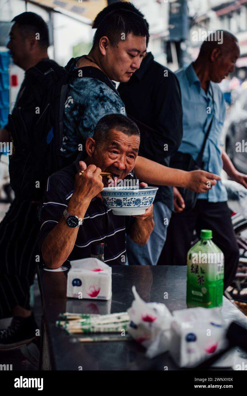 Chinese man eating ramen Stock Photo - Alamy