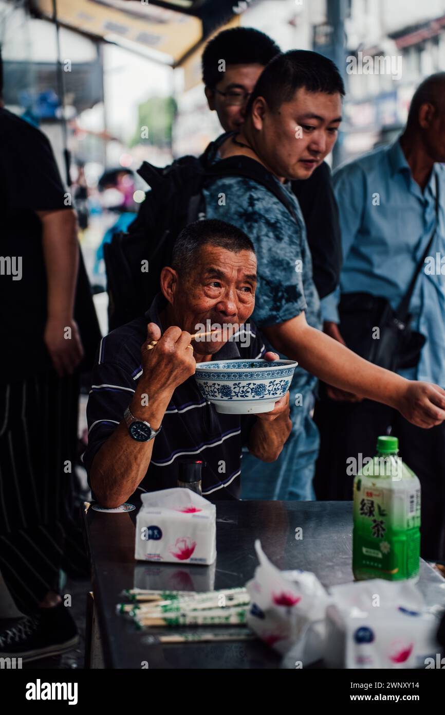 Chinese man eating ramen Stock Photo - Alamy