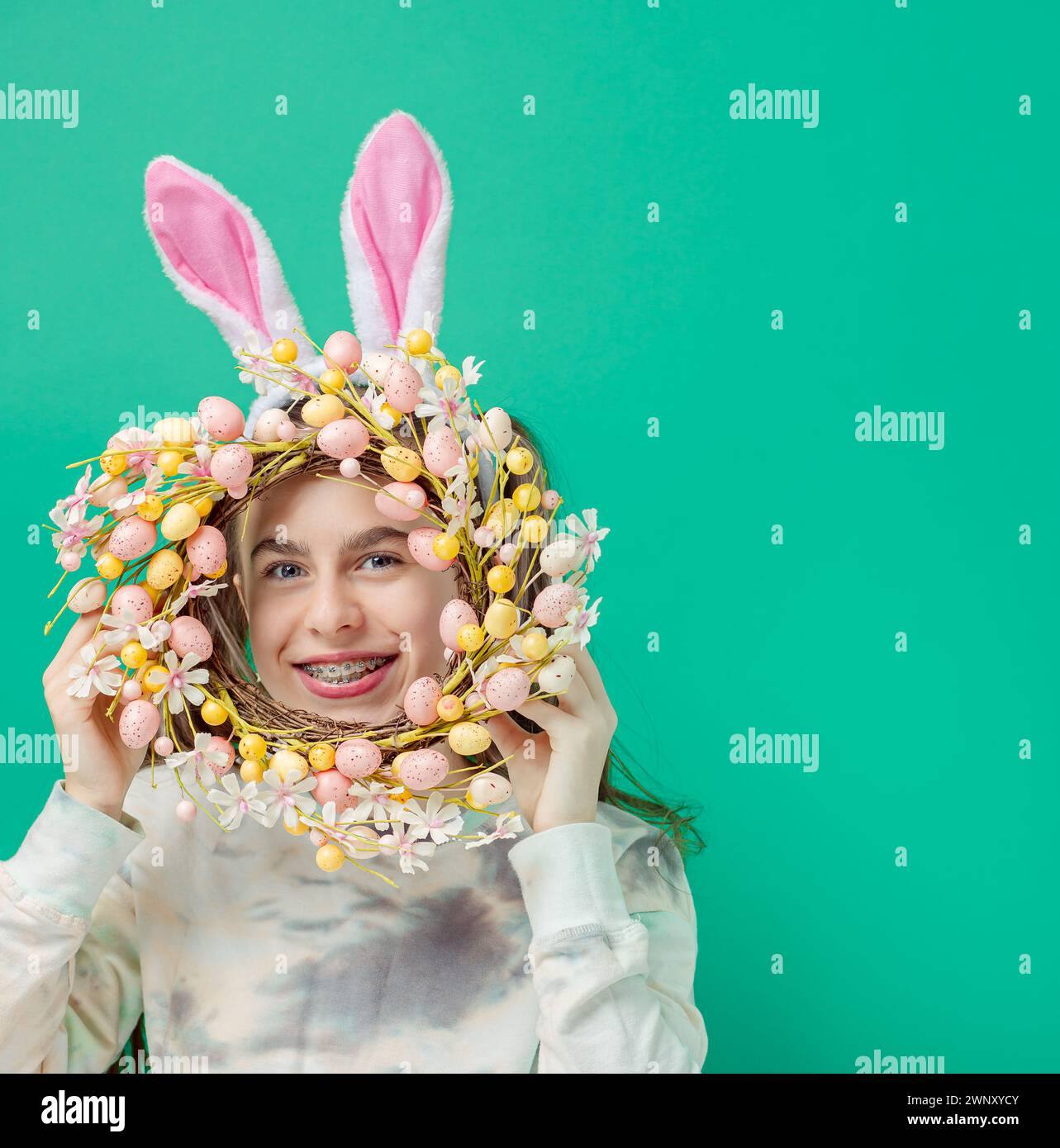 Happy Easter. Girl with joyful smile, in shiny pink rabbit ears and ...