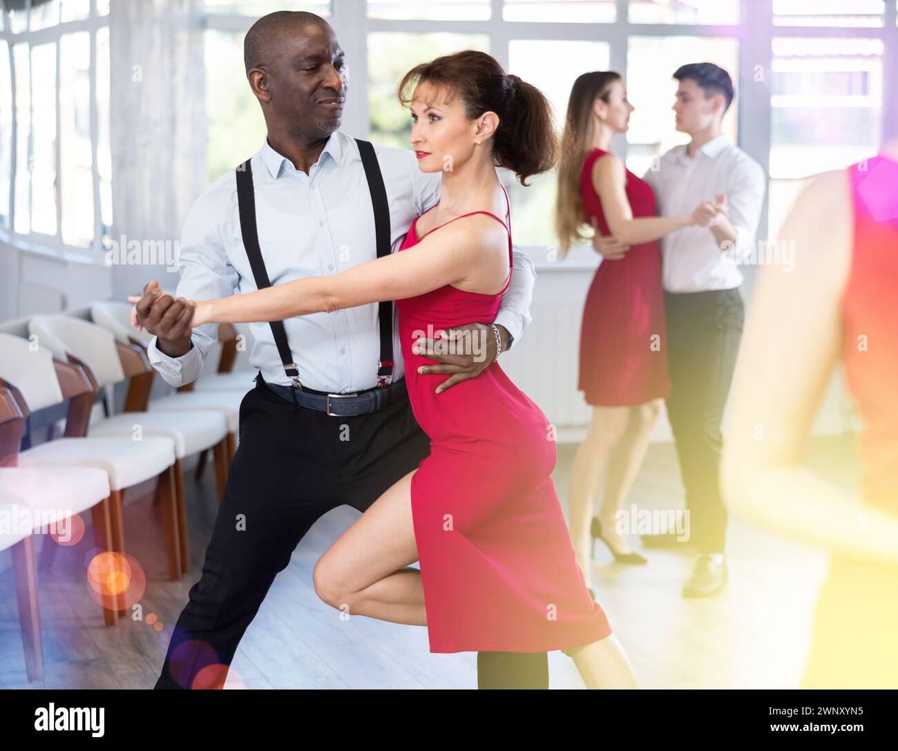 African man and woman dancing tango in couple during lesson at studio Stock Photo - Alamy