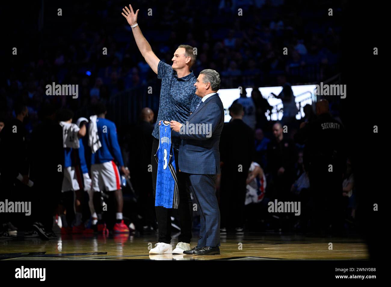 Former Orlando Magic forward Pat Garrity, left, is honored by Magic CEO ...