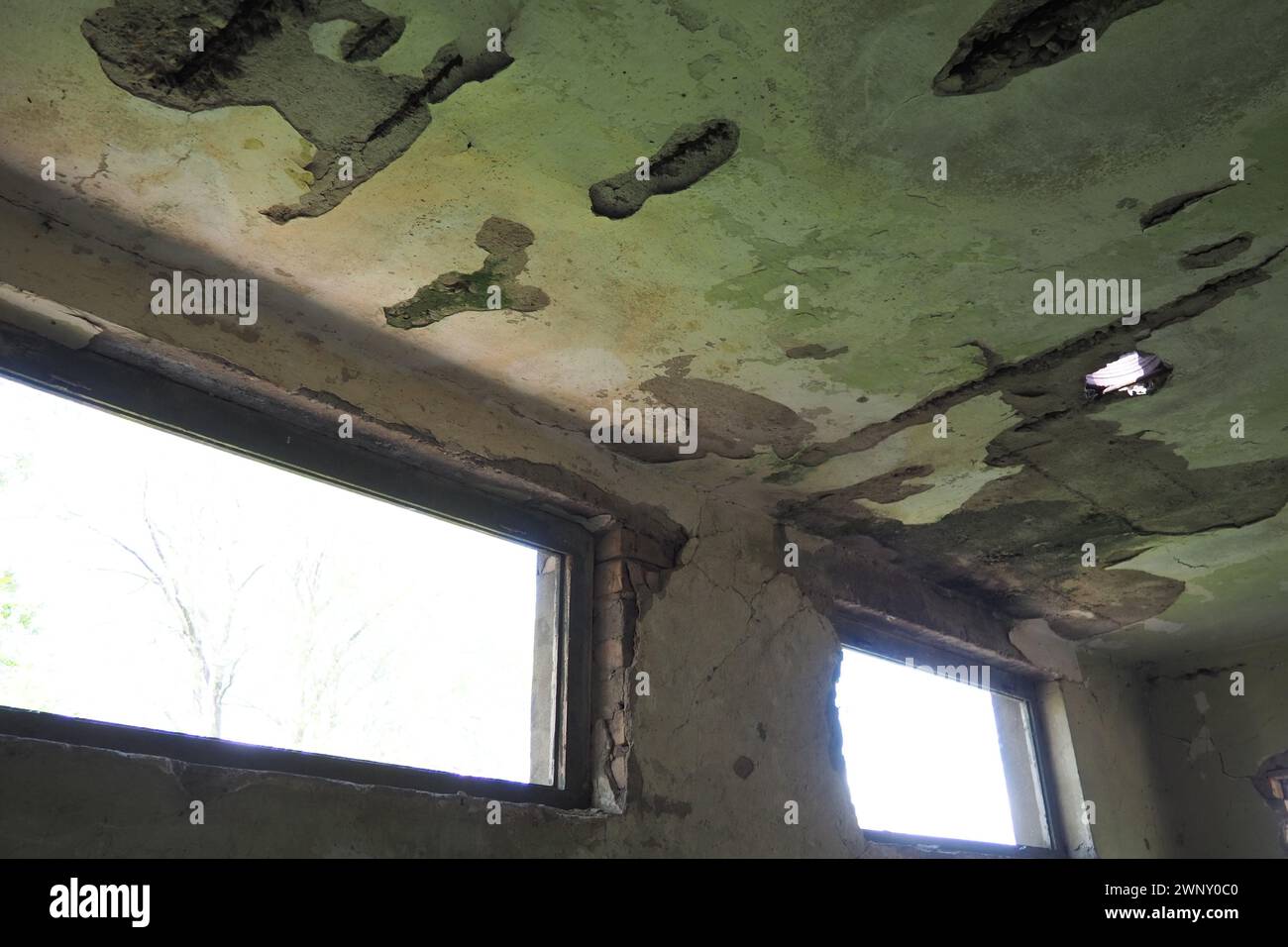 Abandoned building interior. A shabby desolate room with empty broken ...
