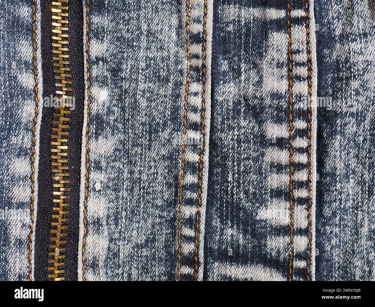 Close-up denim with seams and locks. Heavily shabby worn jeans. Metal ...