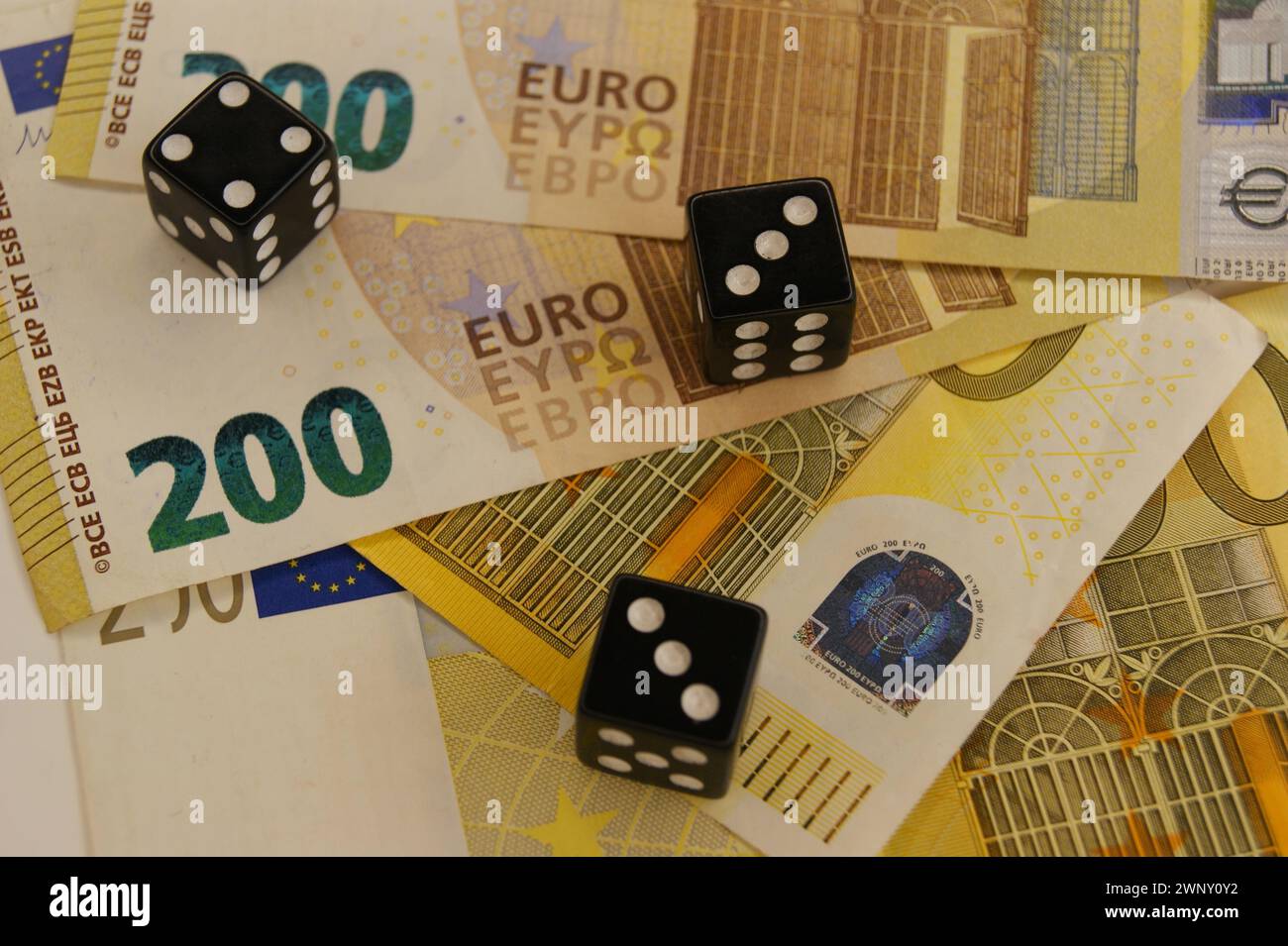 Three dice on new 200 euro banknotes Stock Photo - Alamy
